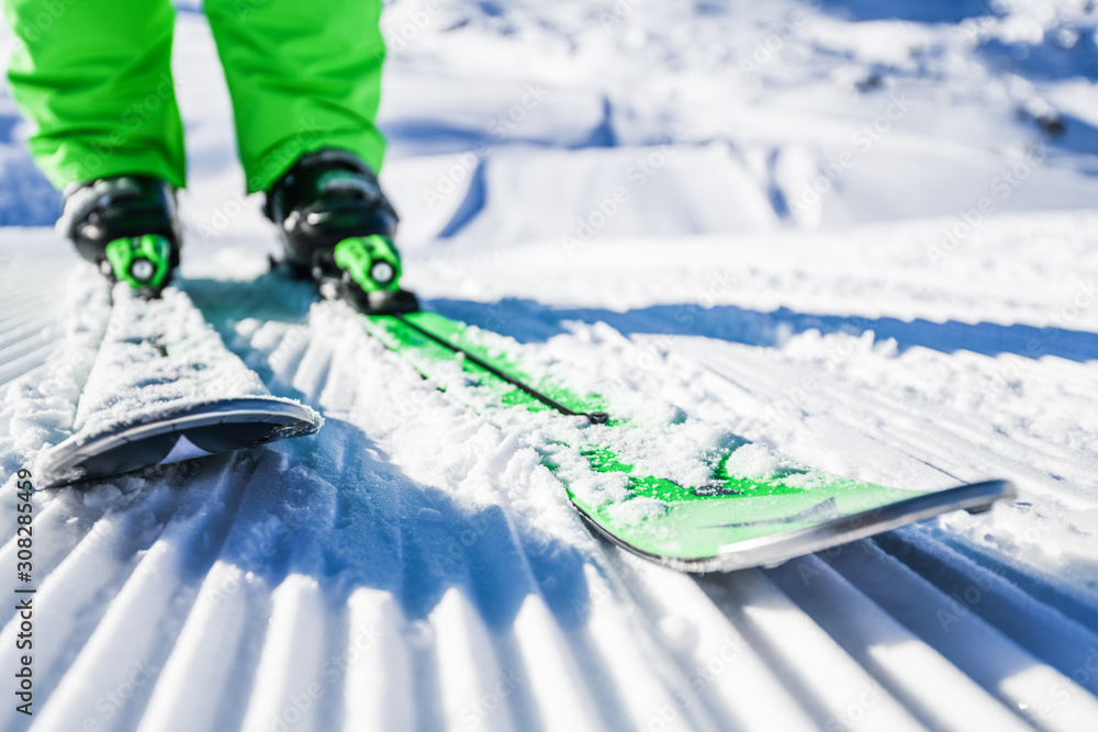 Skis and boots detailed from front view. New groomed piste or slope ...