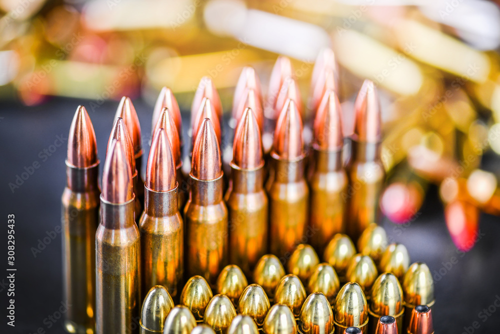 Various kind of bullets or ammonution on dark stone table. Bullet pile ...