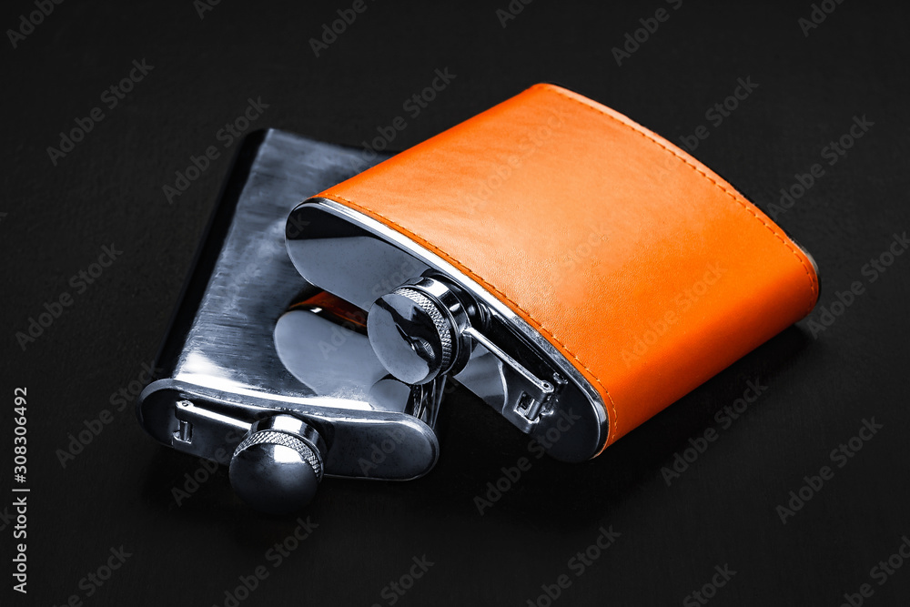 Flasks for alcohol on the table. Steel flask with leather trim on a ...