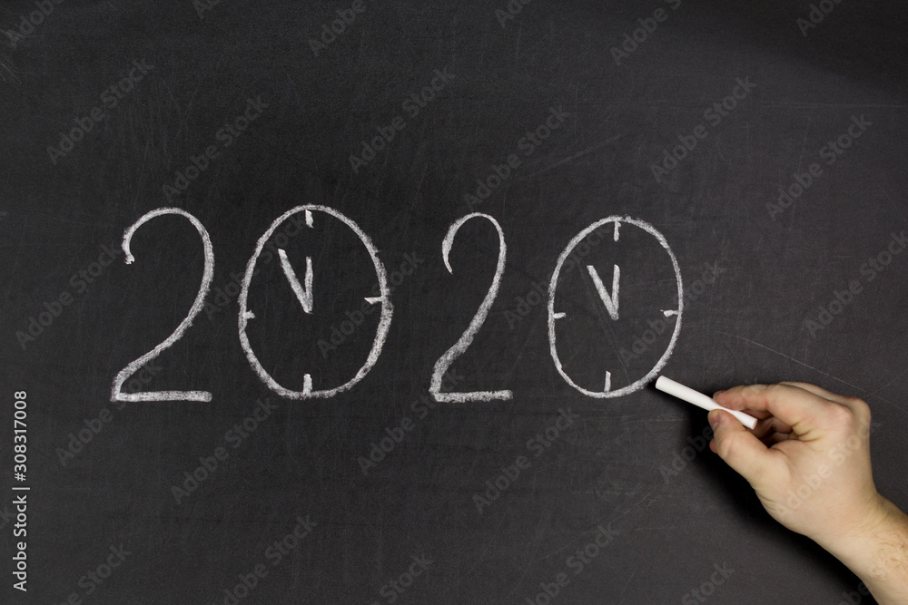 Human hand drawing new year concepts 2020 countdown clock on chalkboard ...