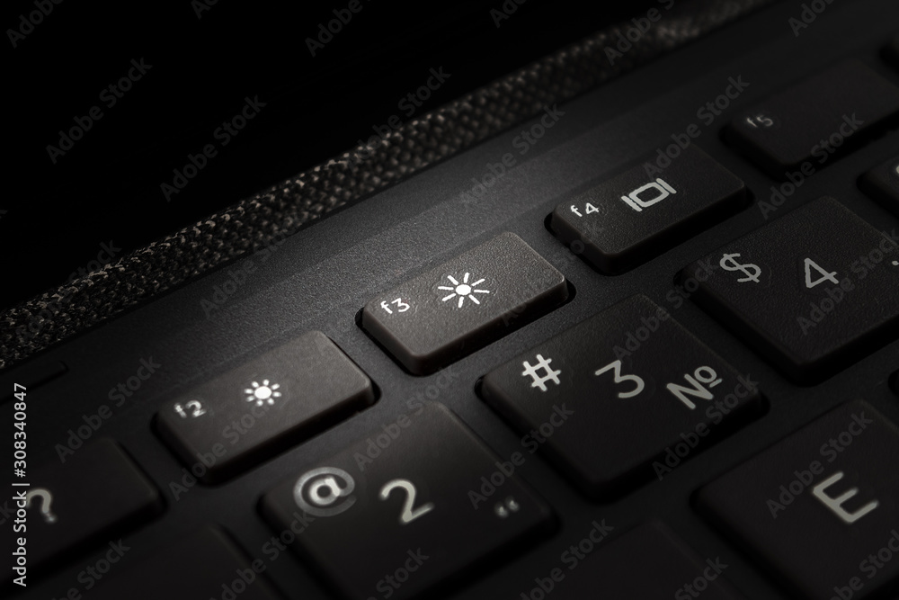laptop computer keyboard with backlight icon on the key, the concept of ...