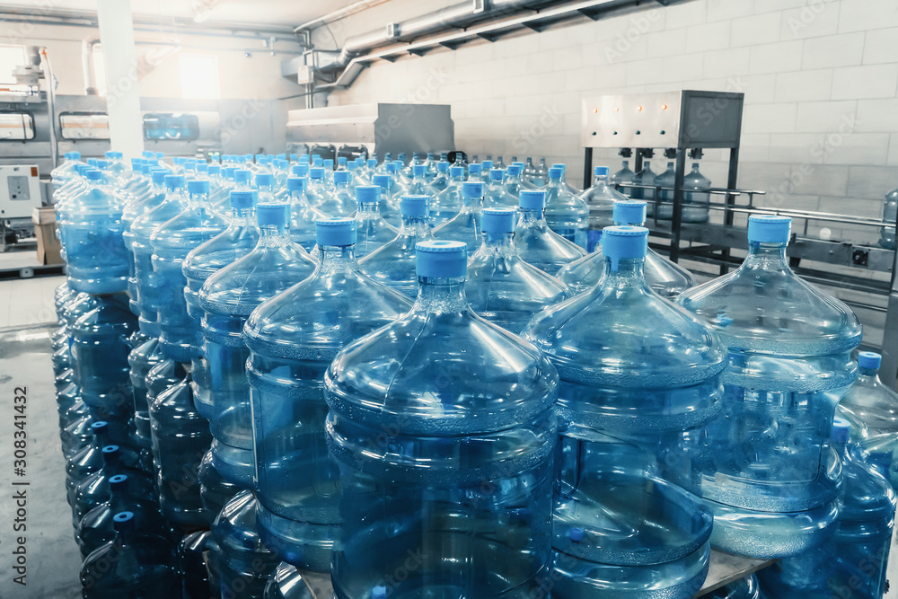 Gallons or plastic bottles of purified drinking water on pallets in ...