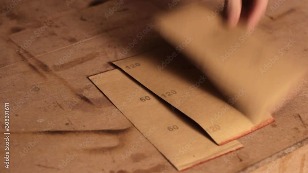 Laying down different types of sandpaper with different levels of grit ...