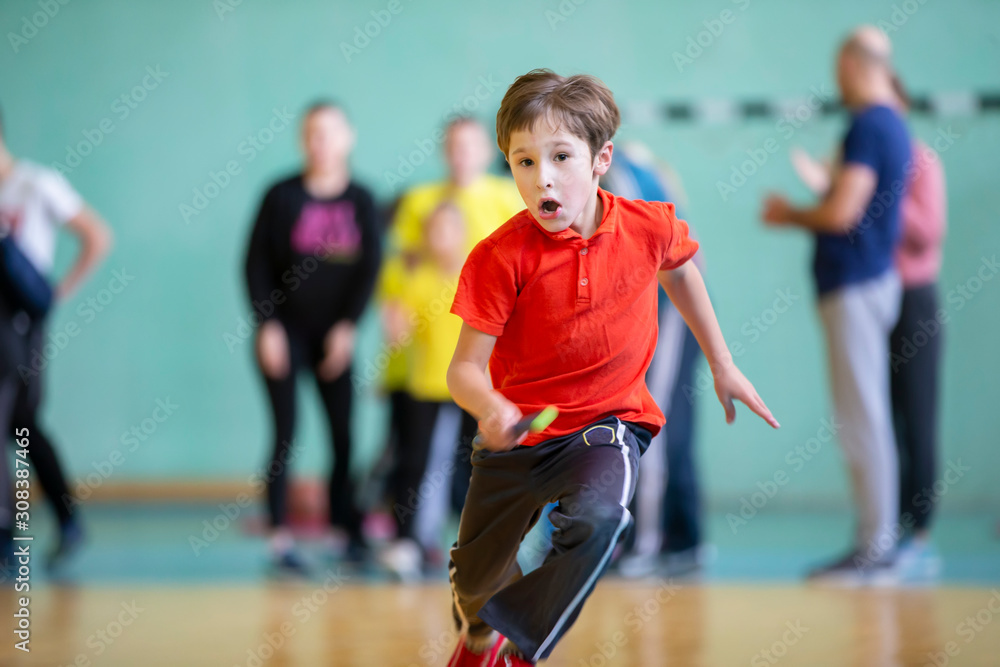 Child in the gym. A schoolboy in a physical education lesson. Relay ...