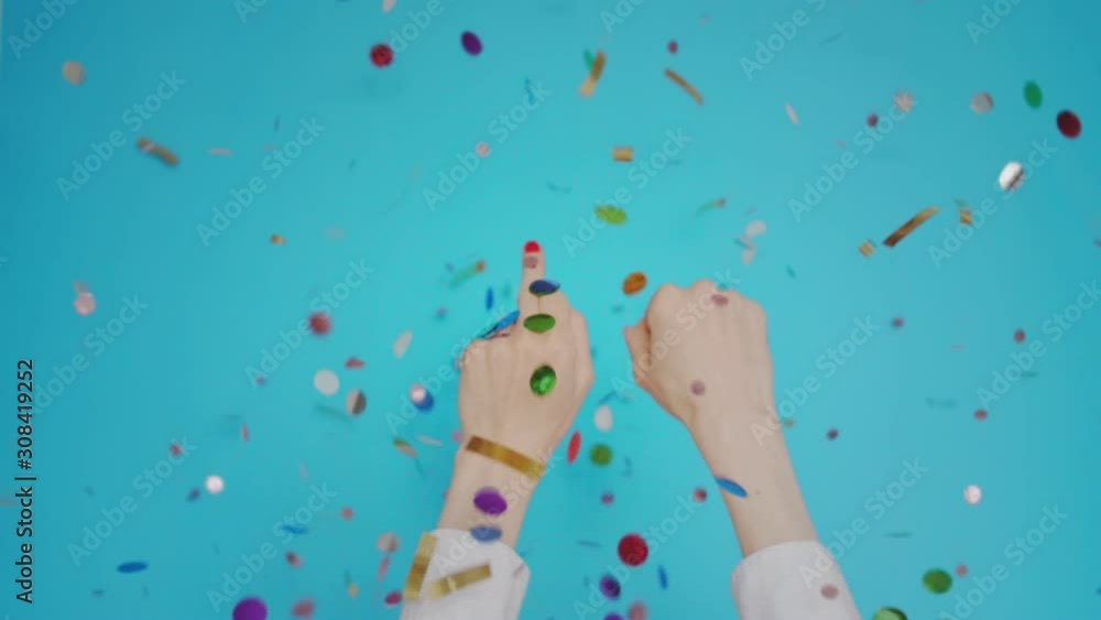 Womans hands isolated on blue background with confetti falls. Woman ...
