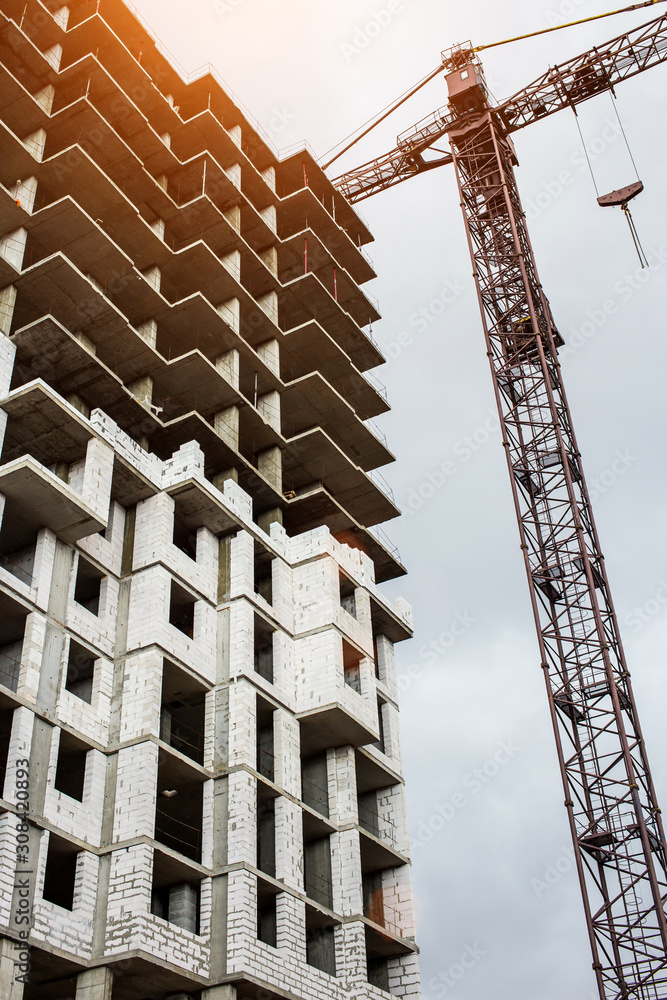 Foto de Construction site background. Hoisting cranes and new multi ...