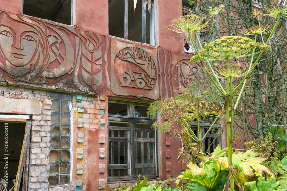 An old abandoned Soviet school building decorated with bas-reliefs from ...