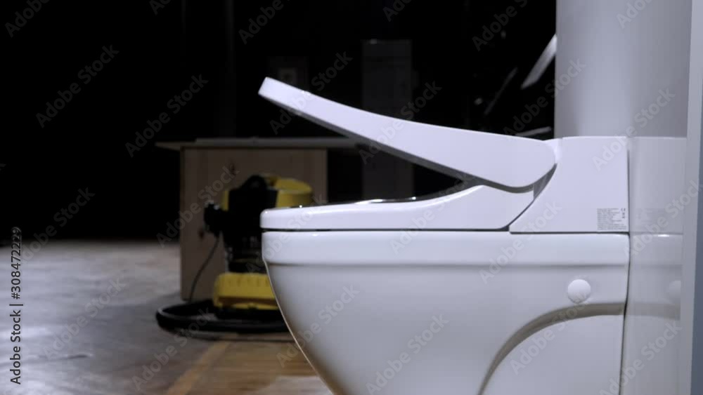 White automatic toilet. Modern technological solution. Raising the lid ...