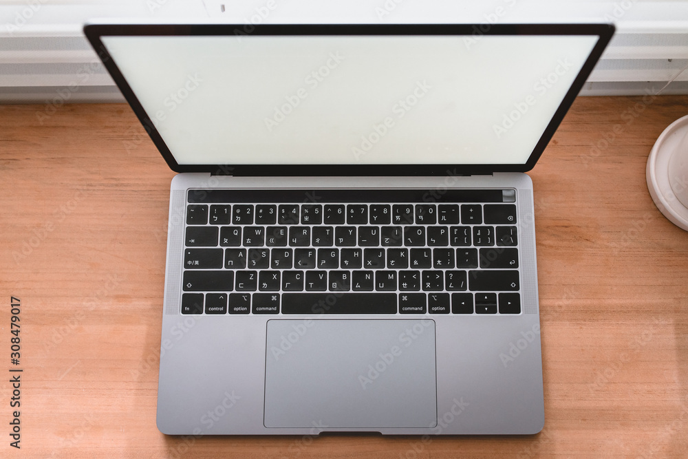 Conceptual workspace, Laptop computer with blank white screen on table ...