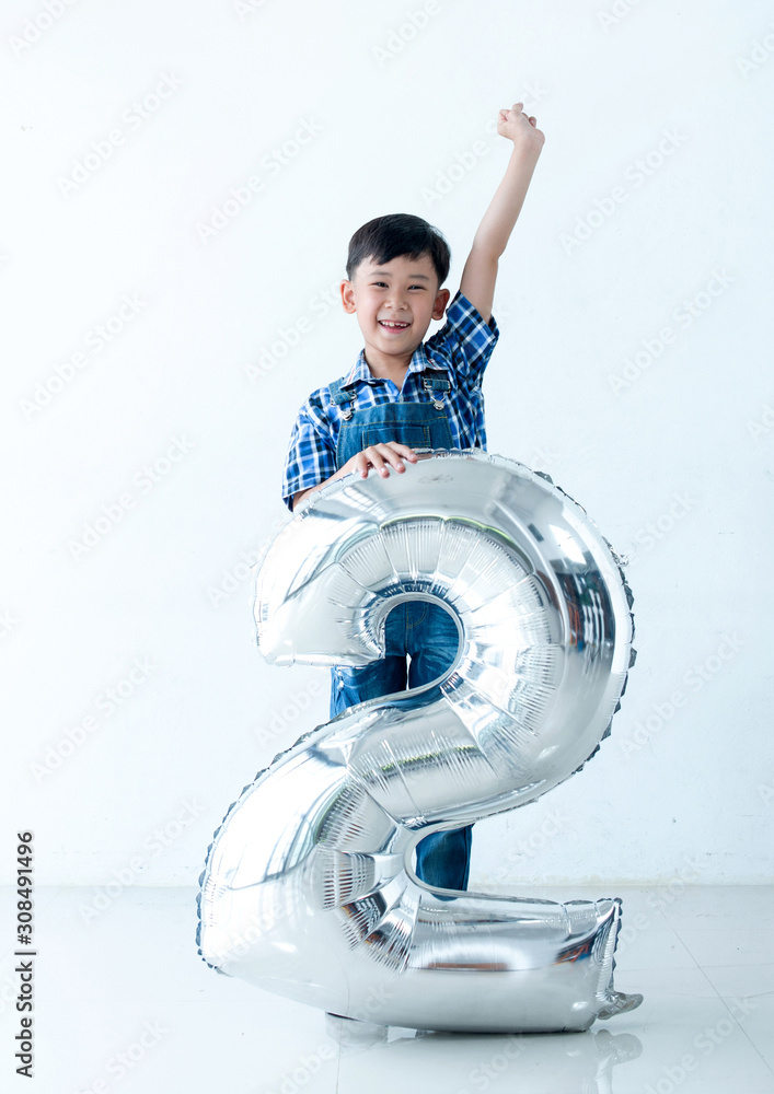 Asian happy boy with silver number 2 balloon on white background, Asian ...