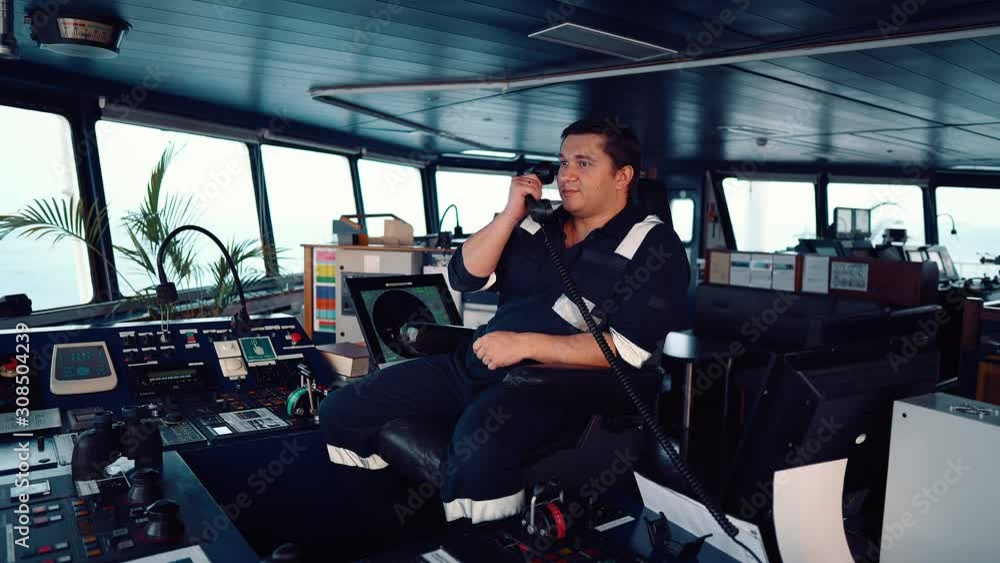 Marine Deck Officer or seaman on navigation bridge of vessel or ship ...