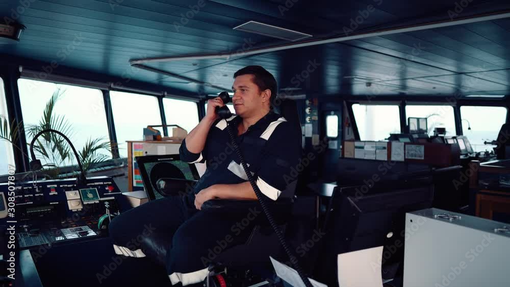 Marine Deck Officer or seaman on navigation bridge of vessel or ship ...