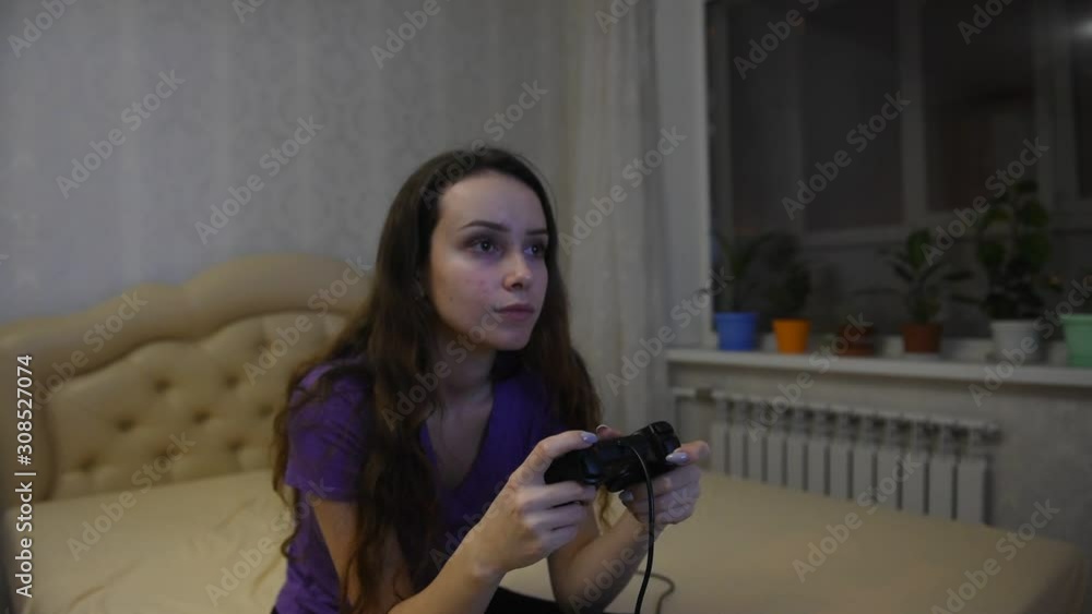 Sad girl loses the video game at home at night. Excited gamer woman ...