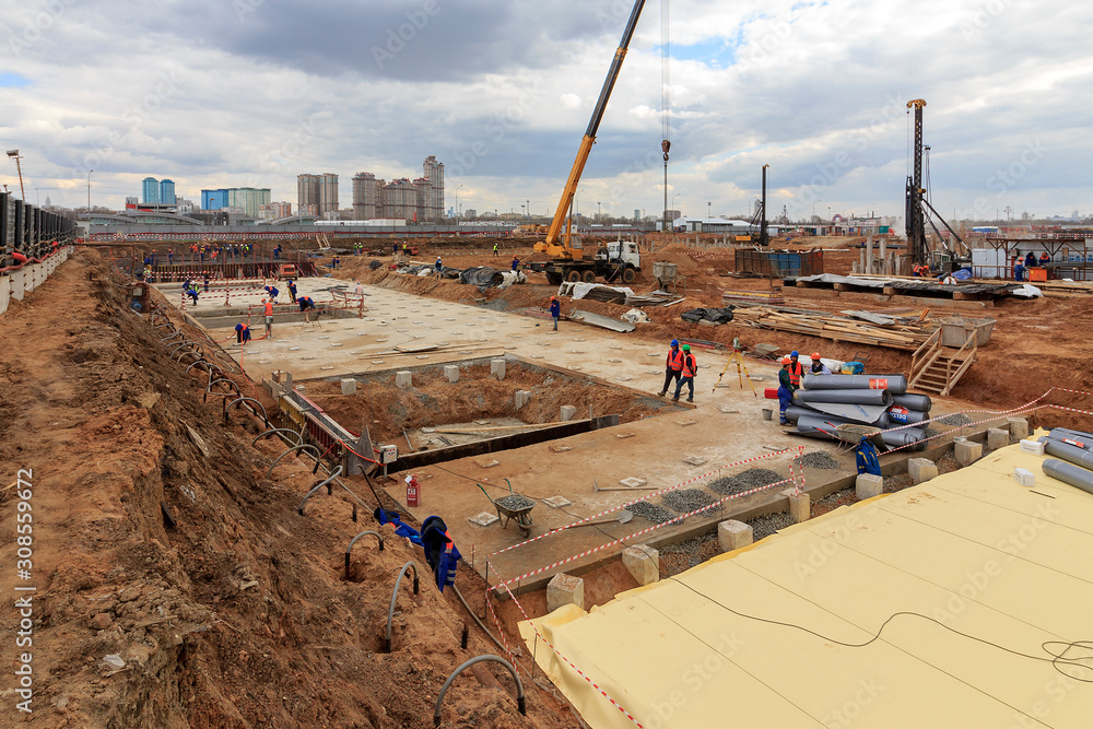 Truck crane at construction site. Details of construction site with crane lifting prefabricated ...