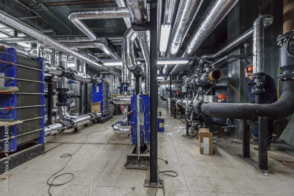 pumping station under construction. pipes of central heating system and ...