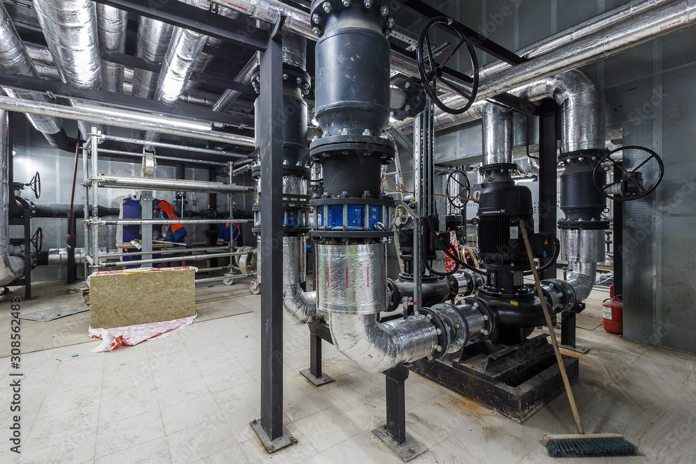 pumping station under construction. pipes of central heating system and ...