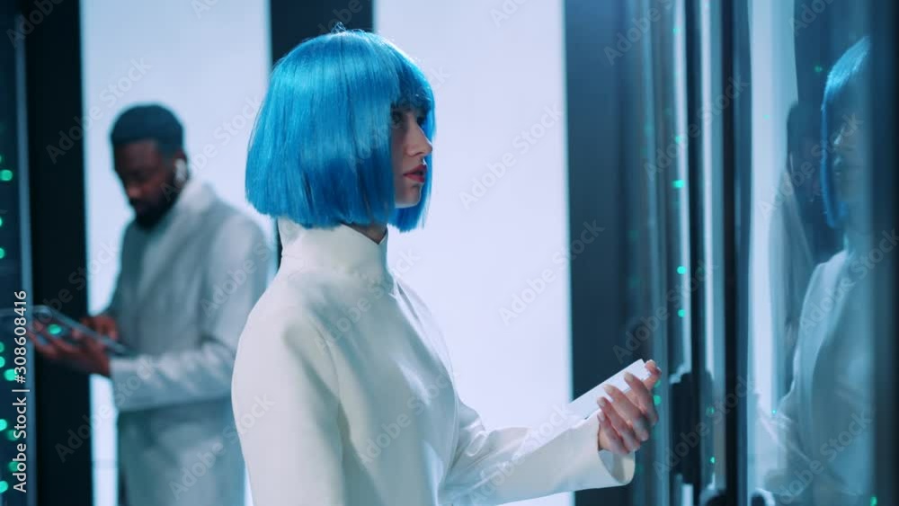Robotic woman IT admin walking inside server cabinet, opening ...