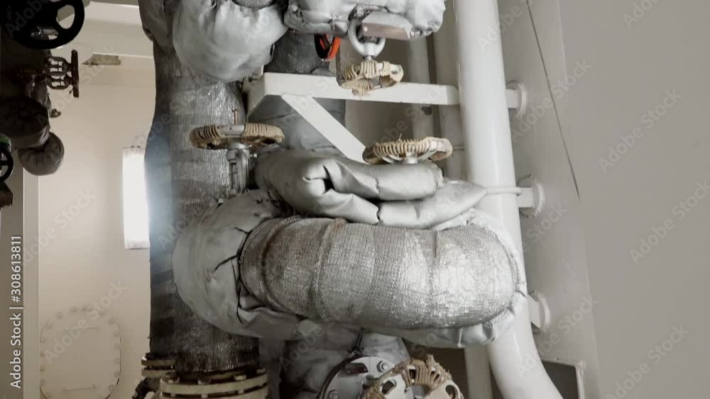 various pipelines with grey isolation and round valves twist in ...