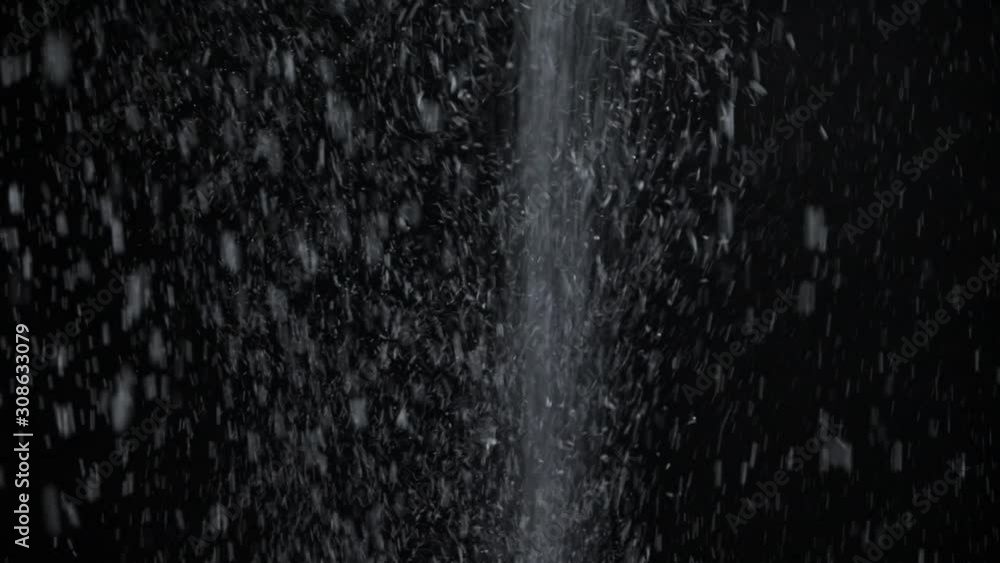 Snow from spray can stream up many times and then fall down slowly on ...
