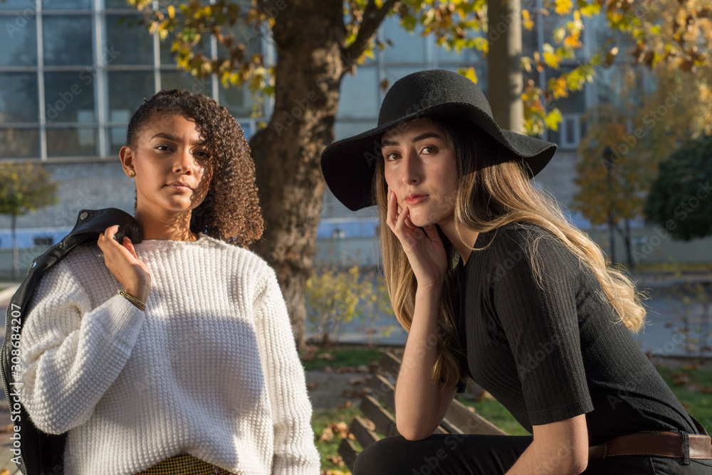 Portrait of two beautiful mexican millennial generation girls. Autumn ...