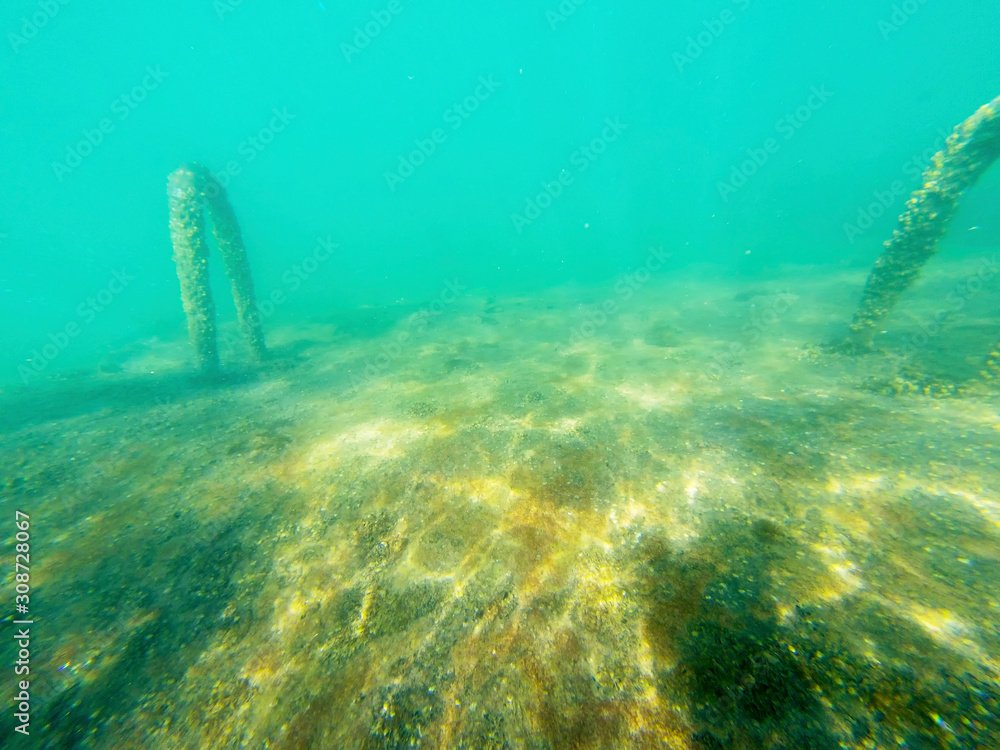 Concrete block under water. Reflection of sun rays under water on a ...