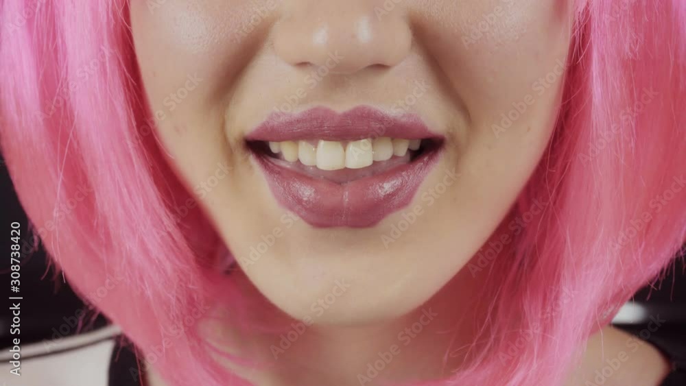 Girl with the lips of the devil. Young beautiful girl with pink hair. A ...