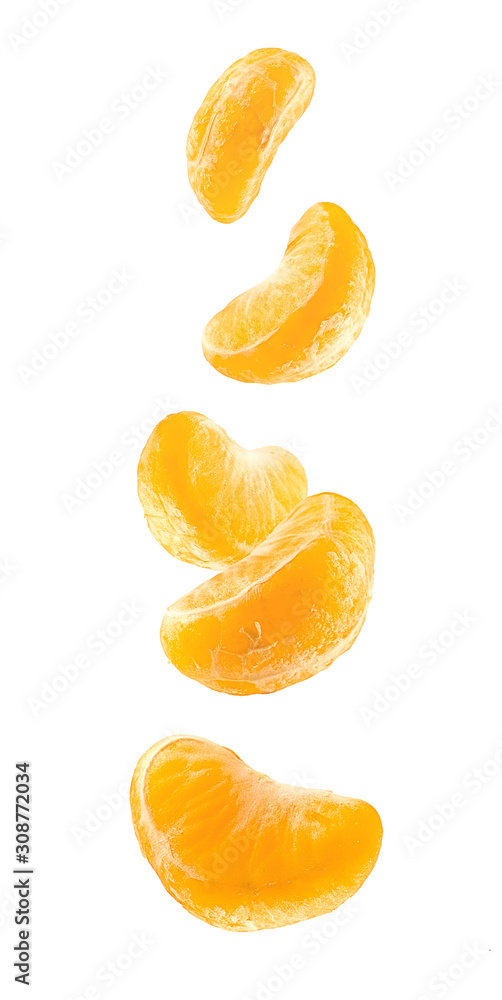 Pieces of peeled mandarin in the air isolated on a white background ...