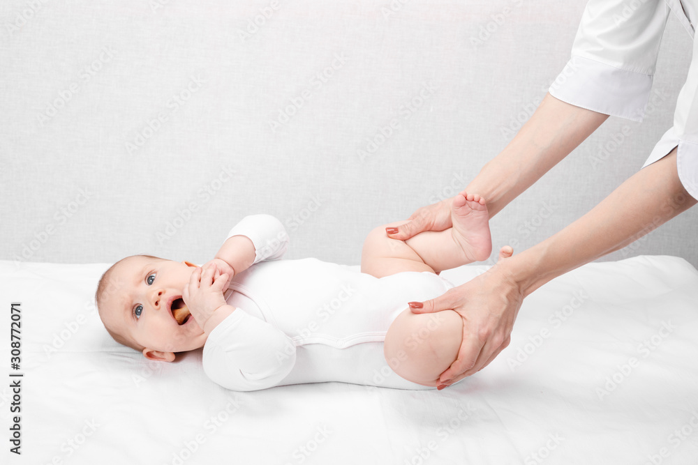 Little baby receiving osteopathic treatment of her leg to prevent hip ...