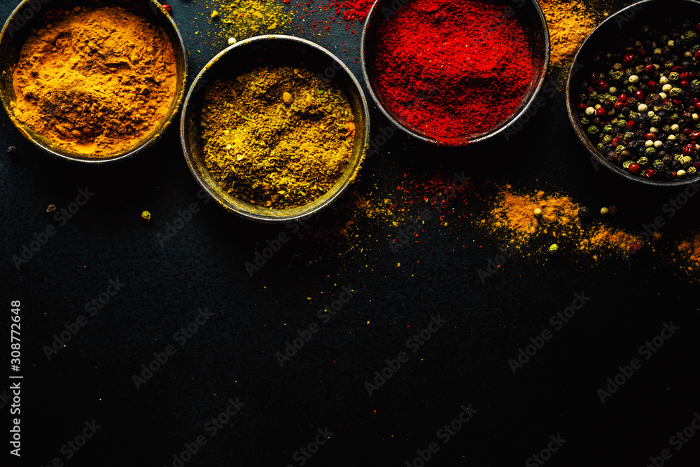 Colorful spices on dark background Stock Photo | Adobe Stock