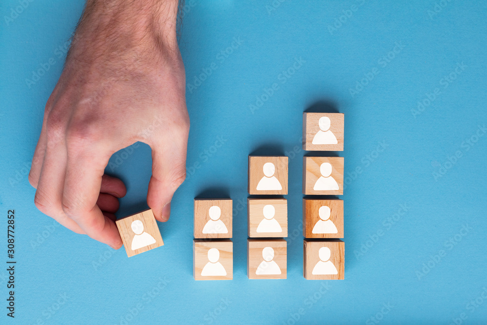 Hand adding a new team member to a group. Business management concept ...