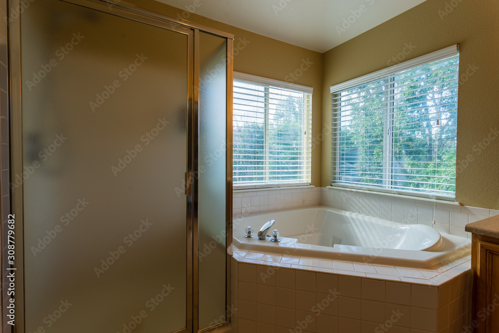 Contemporary master bath with frosted-glass shower, corner bathtub, and ...