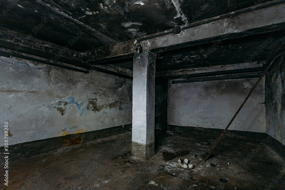 Dark and creepy dirty abandoned underground basement afrer fire. Walls ...