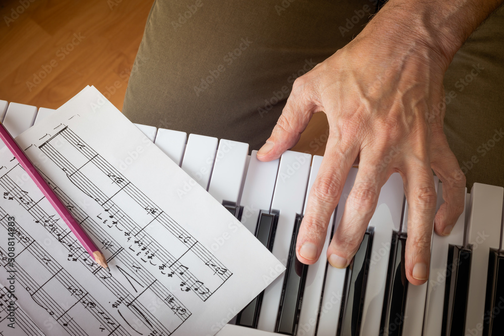 PUBLIC DOMAIN MUSIC SCORE. Close up detail on the hand of a musician ...