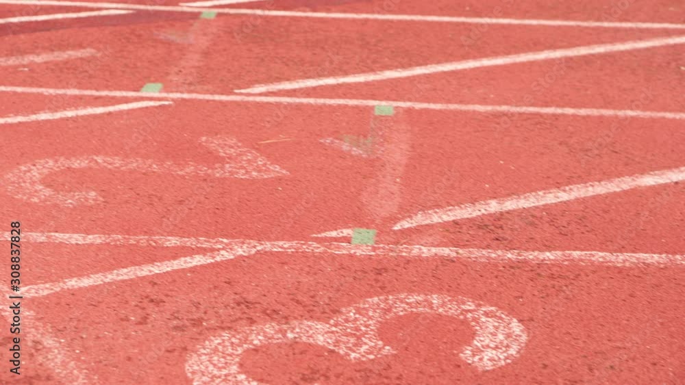 Running track, starting line numbers. Panning shot of athletics track ...