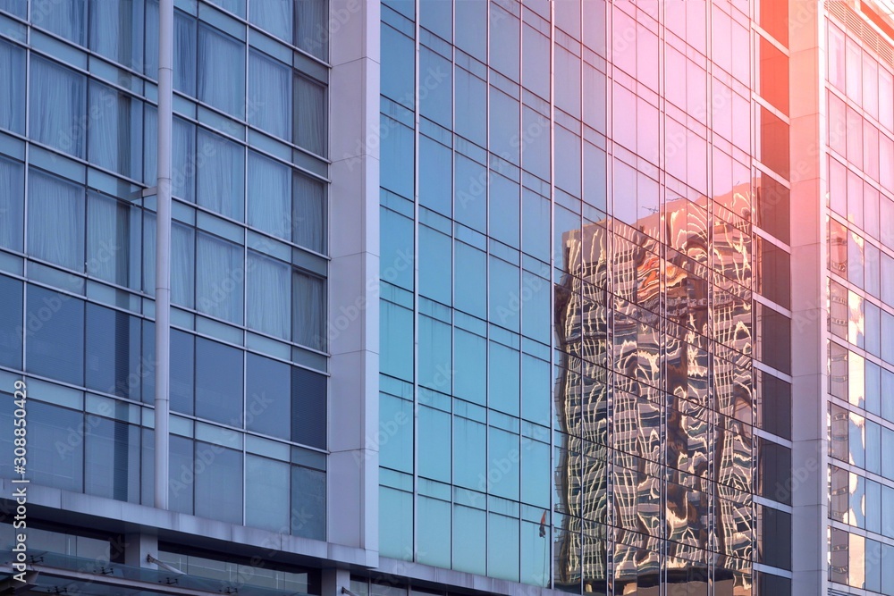 Low angle and side view of blue glass wall with reflection pattern of ...