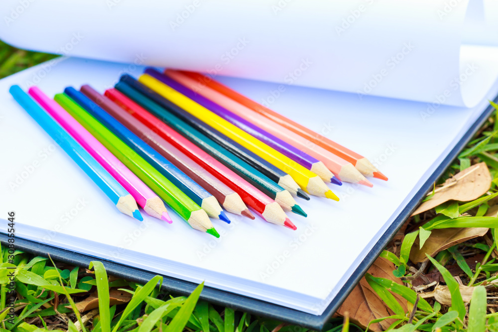 hand open white paper draw and crayon are on the paper.The white paper ...