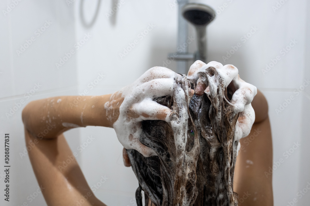 Close up back view or behind view young Asian woman washing hair in ...