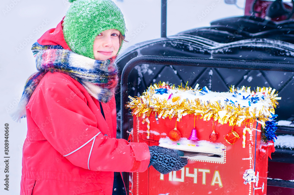 Cute happy child boy girl sends a letter to Santa Claus. Preparing for ...