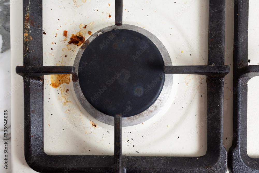dirty surface of kitchen gas stove with grease and soot stains. top ...