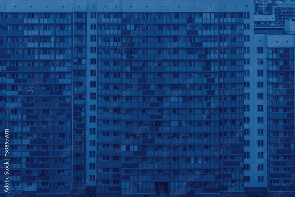Color of the year 2020 classic blue. Facade of high-rise multi-storied ...