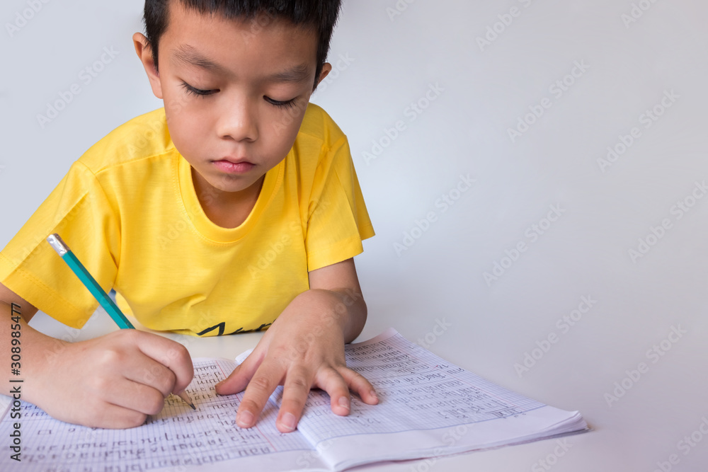 kids doing homework writing and color in their notebook at home ...