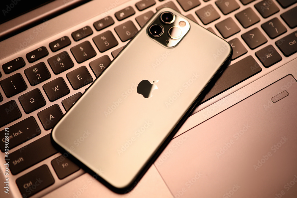 Apple iphone pro on laptop keyboard Stock Photo | Adobe Stock