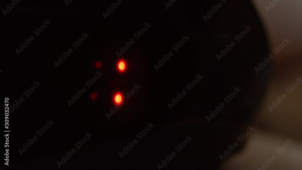 Close-up of black digital clock screen showing 4.00. Blinking red ...