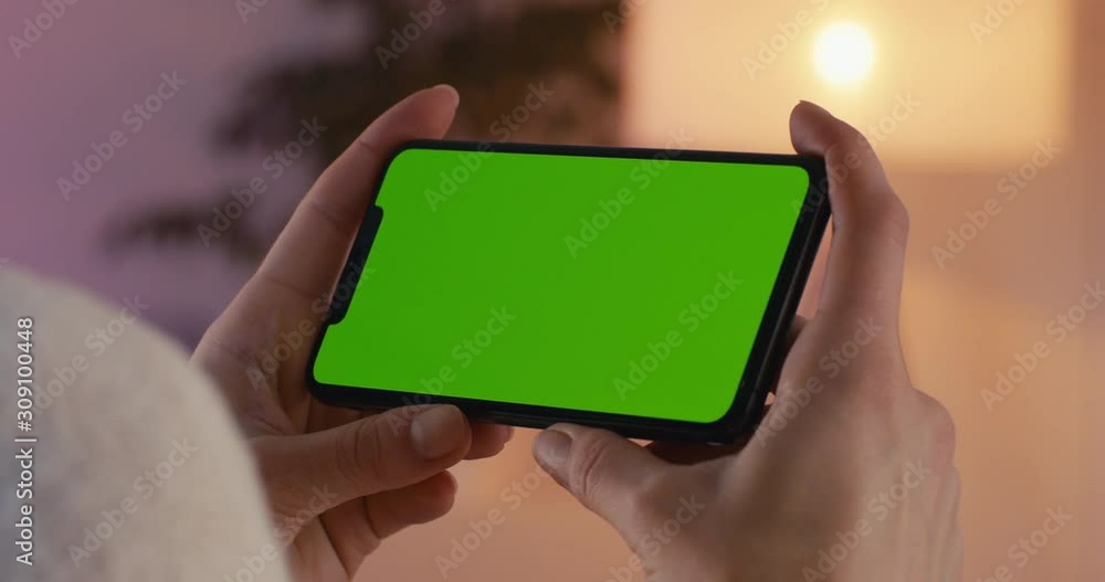 GREEN SCREEN CHROMA KEY CU Caucasian female using generic smart phone ...