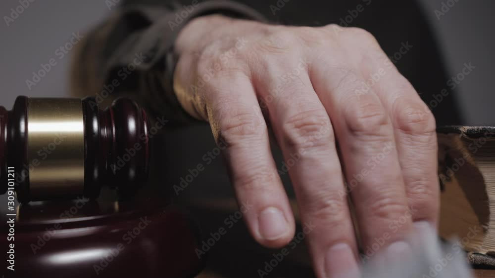 The concept of bribery in court. Close-up of the judge's hammer in the ...