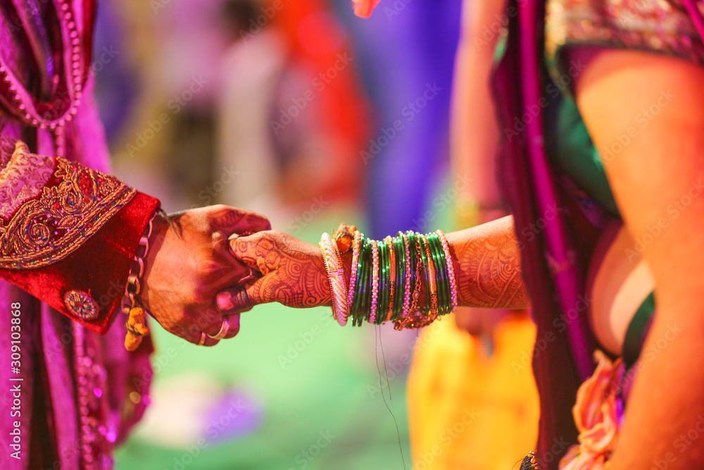 Traditional indian wedding ceremony, groom holding hand in bride hand ...