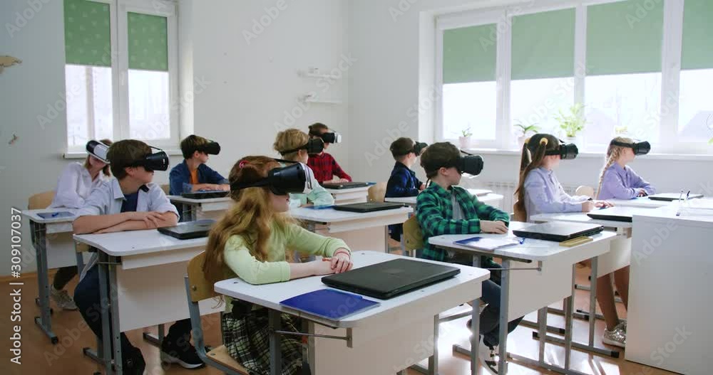 Lesson in cyber space, modern school, childs in virtual reality glasses ...