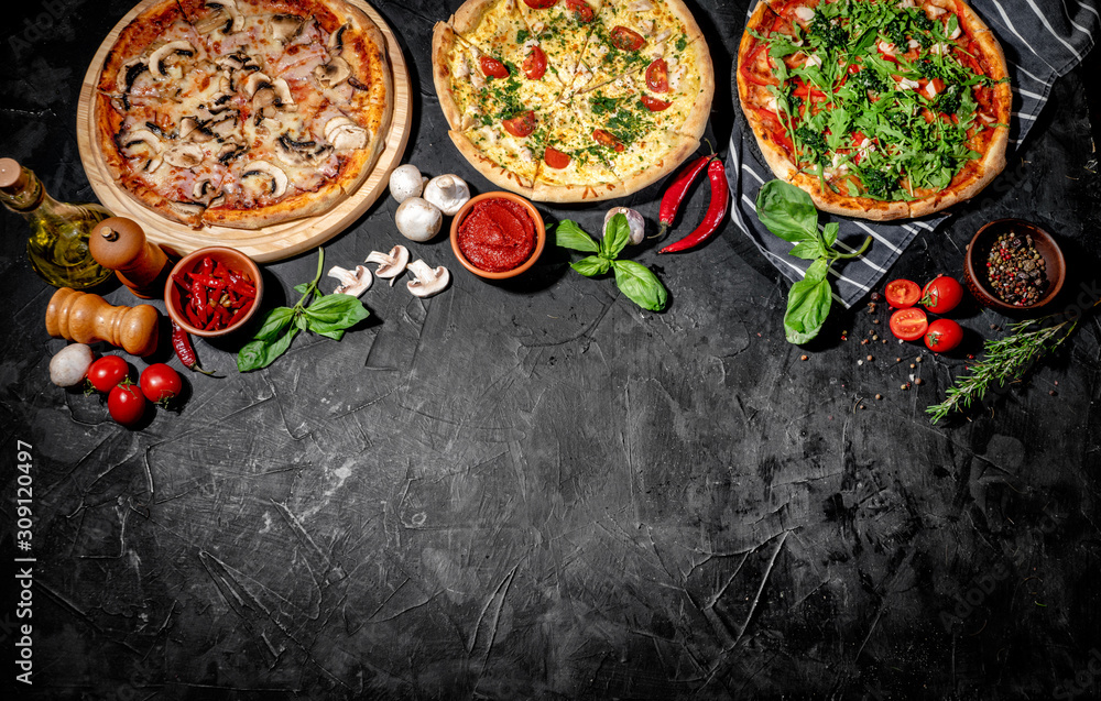 Traditional Italian pizza, vegetables, ingredients on a dark background ...