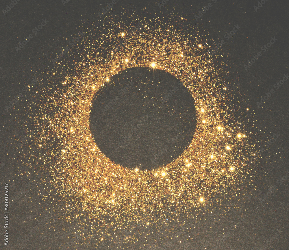 Abstract round frame with golden glitter sparkle on black background ...