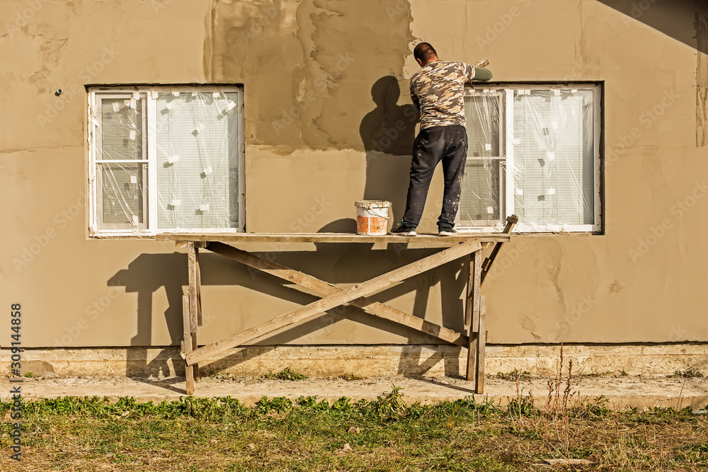 House façade insulation and plastering works. Plastering slabs of ...